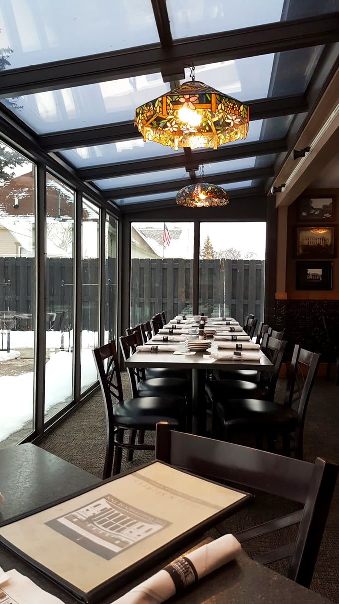 The sunroom dining area bathes you in natural light by day and glows with stained glass warmth by night&mdash;ambiance you can't manufacture.
