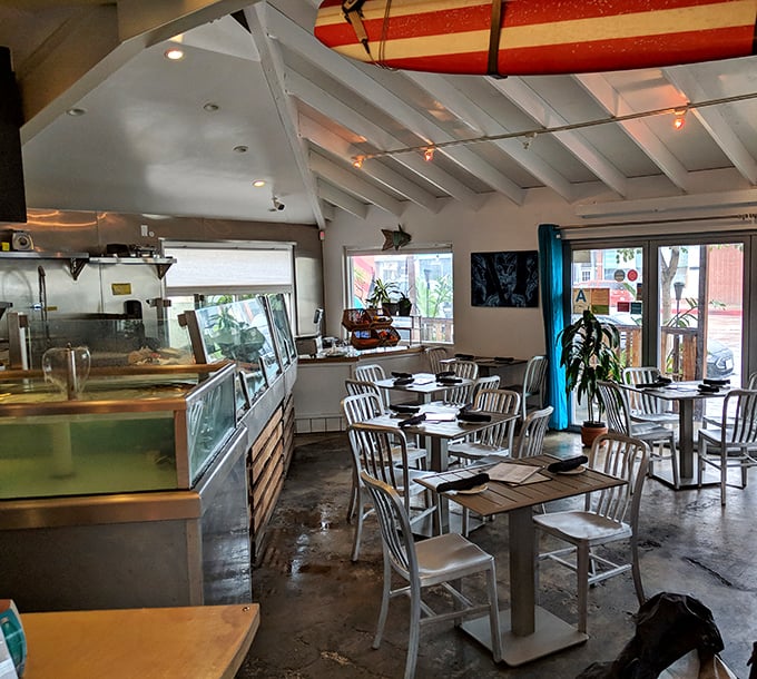 The dining room feels like being invited to a cool friend's beach house – casual elegance with surfboards overhead keeping things from getting too serious.