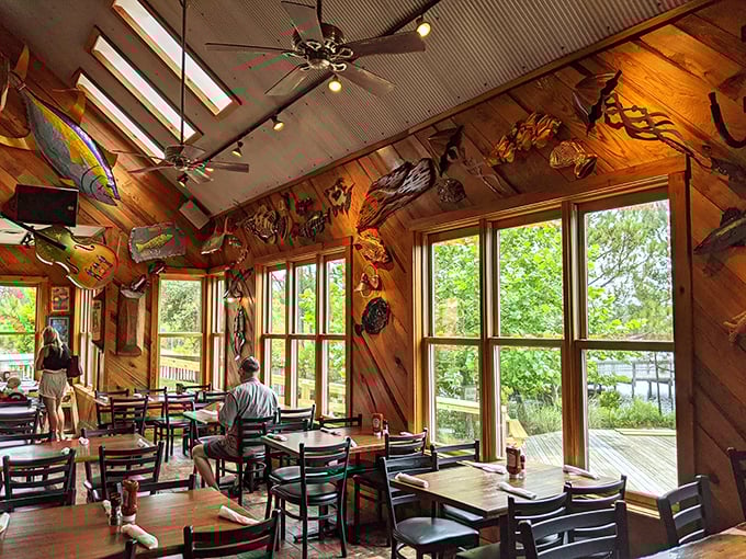 Sunlight streams through windows framing wooden walls adorned with mounted fish. It's like dining inside the world's coziest fishing tale.