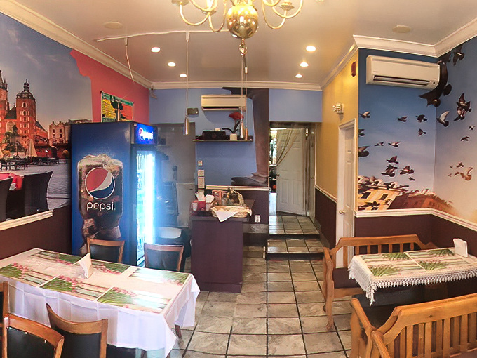 The dining room feels like Poland's living room, where blue walls and magenta accents create a homey, unpretentious atmosphere.