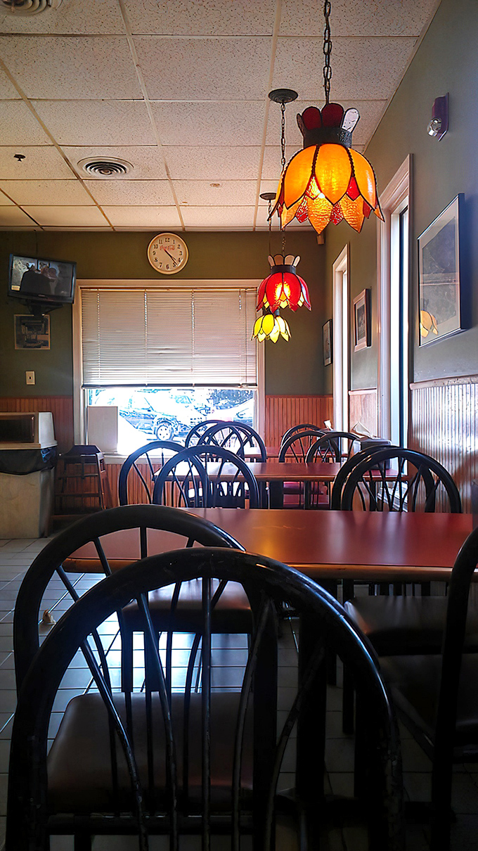 The dining room's wood paneling and colorful hanging lamps create an atmosphere that's part 1970s rec room, part neighborhood gathering spot—entirely comforting.
