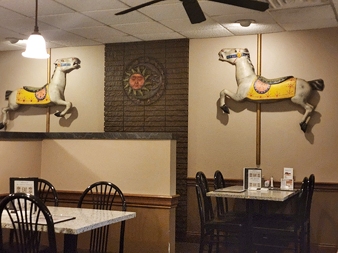 Whimsical carousel horses gallop across the dining room wall – a playful touch that somehow makes perfect sense in this neighborhood treasure.