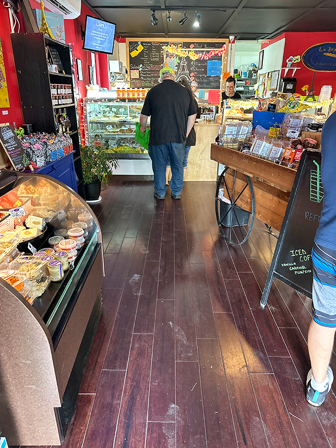 The bakery's interior reveals the true battlefield where willpower goes to die. Notice the customer already surrendering to temptation.