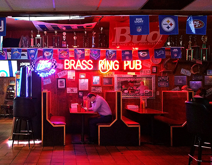 The neon glow creates that perfect dive bar ambiance where great food and conversation flow as freely as the beer.