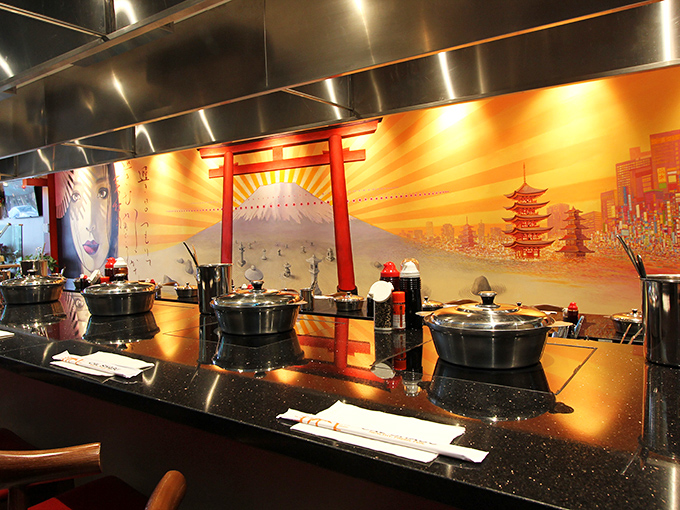 The dramatic backdrop of Japanese-inspired art transforms dinner into an immersive experience. You're not just eating—you're traveling.