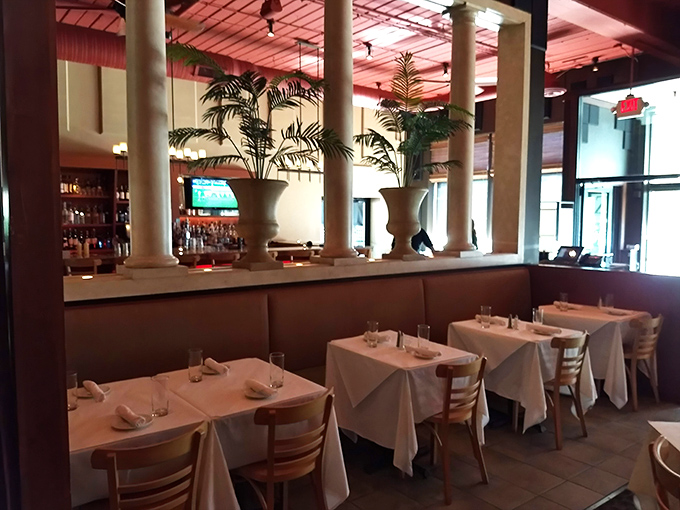 Elegant columns and lush plants create distinct dining zones while maintaining an open, airy feel. The perfect backdrop for both conversation and cuisine.