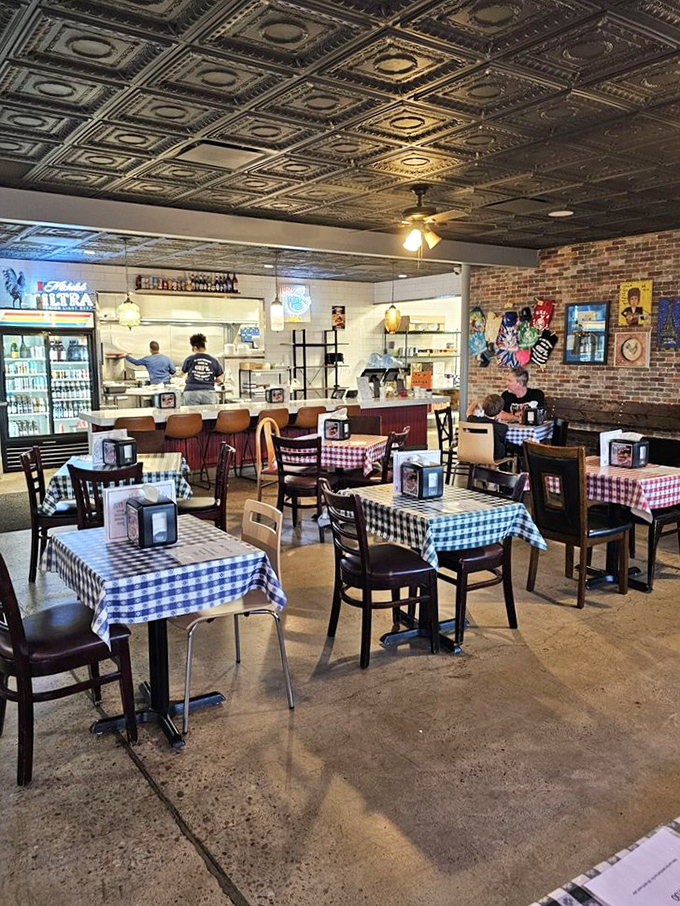 The open kitchen design isn't just practical – it's dinner and a show. Those checkered tablecloths are basically saying, "Get comfortable, you're about to have an experience."