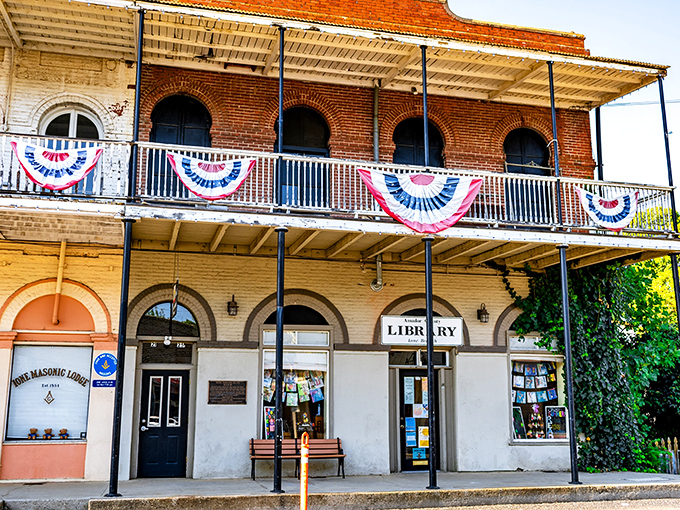 Ione's historic library building stands draped in patriotic bunting, serving as both knowledge keeper and community gathering spot for generations.