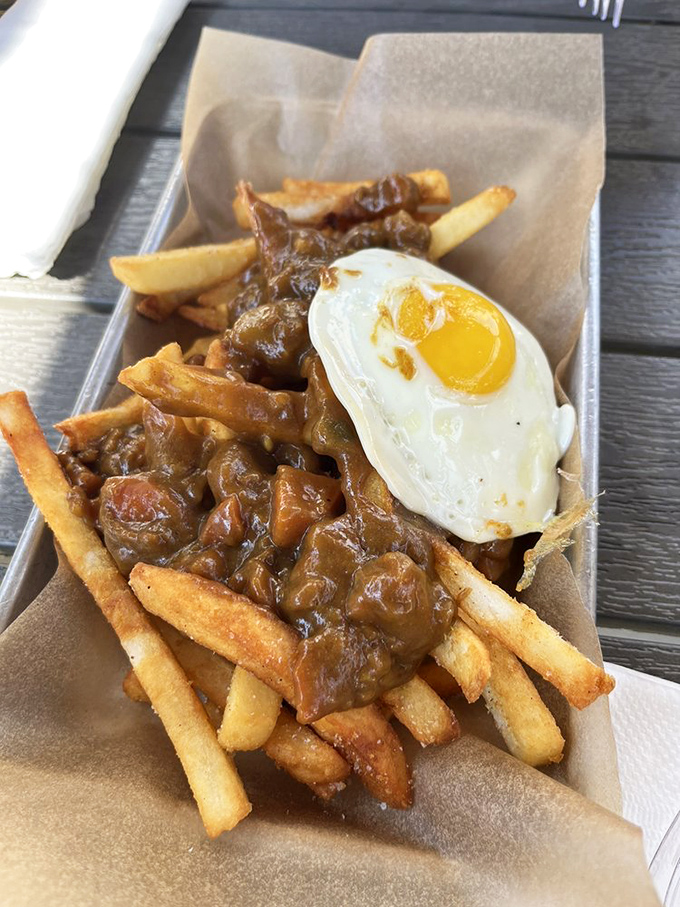 Fries swimming in curry gravy with a sunny-side-up egg &ndash; like breakfast and dinner had a delicious love child.