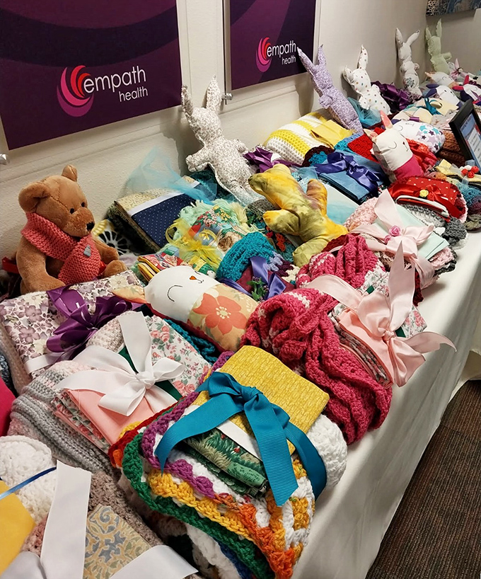 Handcrafted blankets, stuffed animals, and baby items showcase the care that goes into both donations and display at this community-minded thrift store.