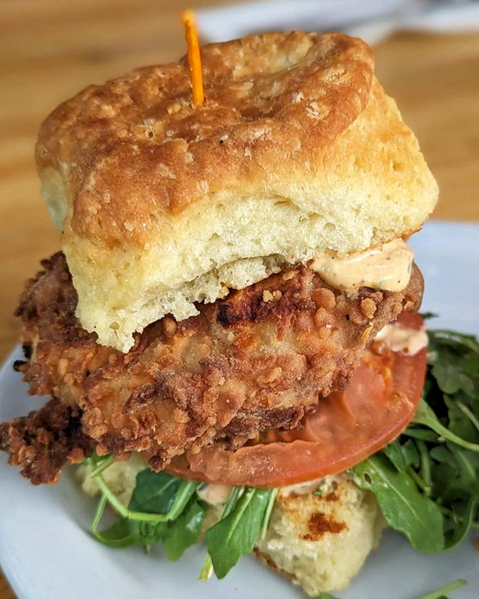 This isn't just a chicken biscuit&mdash;it's architectural perfection with crispy fried chicken, fresh greens, and a golden biscuit that defies gravity.