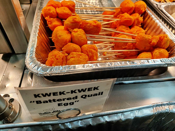 Kwek-kwek &ndash; quail eggs wearing bright orange batter coats that make them look like they're dressed for a tropical vacation.
