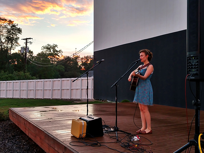 Live music fills the summer air as performers share their talents before the main cinematic event begins.