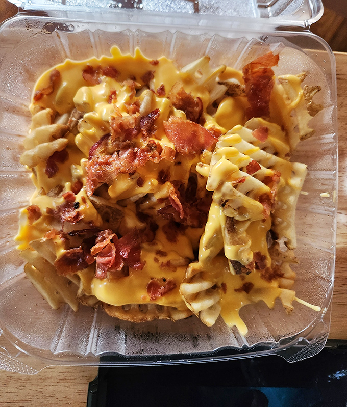 Waffle fries transformed into a cheese-and-bacon playground&mdash;where every forkful is a treasure hunt for the perfect combination of crispy, gooey, and smoky.