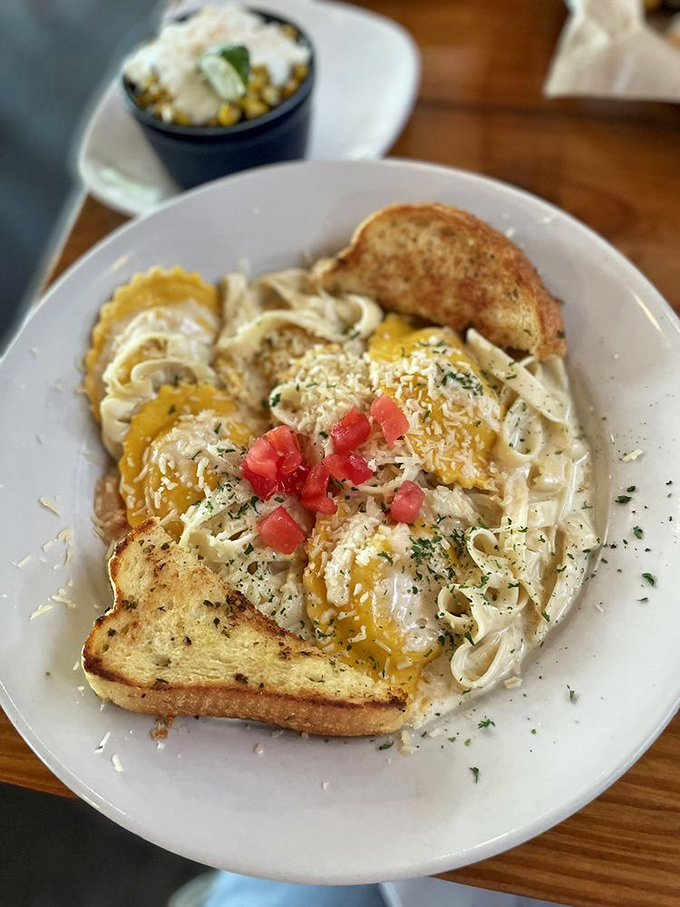 Pasta, eggs, and toast come together in a comfort food symphony that proves seafood joints often hide unexpected treasures beyond their oceanic offerings.