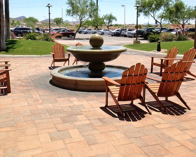 Adirondack chairs surrounding a tranquil fountain offer the perfect spot to contemplate whether you really need those discounted designer sunglasses.