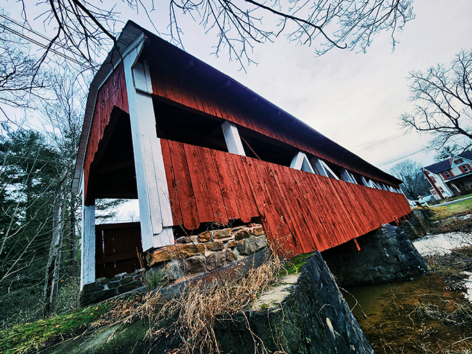 The dramatic angle reveals the bridge's impressive stone foundations&mdash;engineering marvels that have withstood countless spring floods and winter freezes.