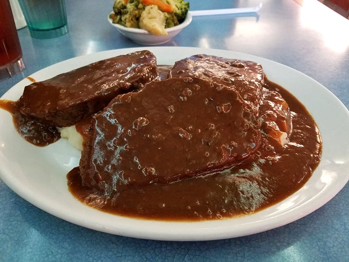 Meatloaf swimming in gravy so rich it could apply for its own tax bracket. Comfort food that hugs you from the inside.
