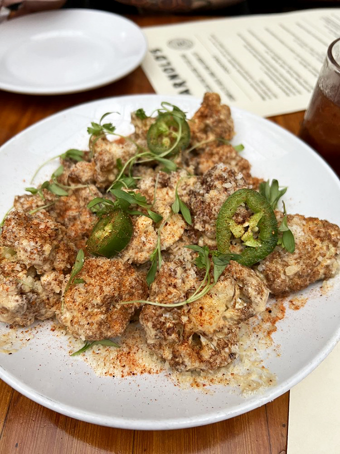 These aren't your average brussels sprouts&mdash;they're the cool cousins who studied abroad. Crispy, spiced, and lounging on a bed of creamy hummus.