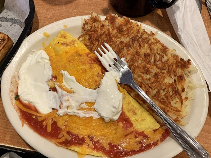 This isn't just an omelet&mdash;it's a sunrise wrapped in protein. Those hash browns have achieved the crispy-to-fluffy ratio that scientists are still trying to explain.