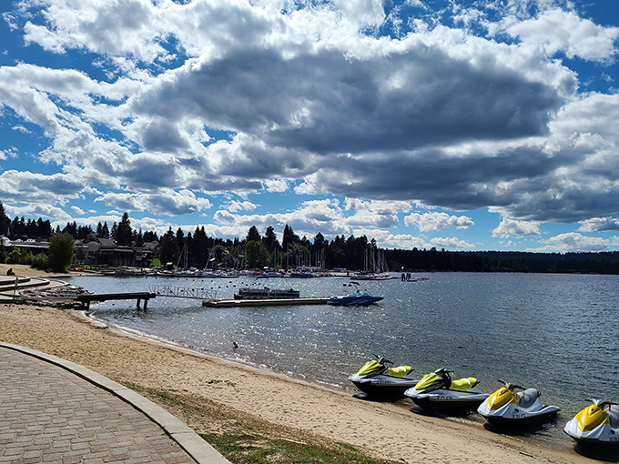 Jet skis waiting patiently for their next thrill-seeker. The lake sparkles like nature's own welcome committee under those dramatic Idaho clouds.