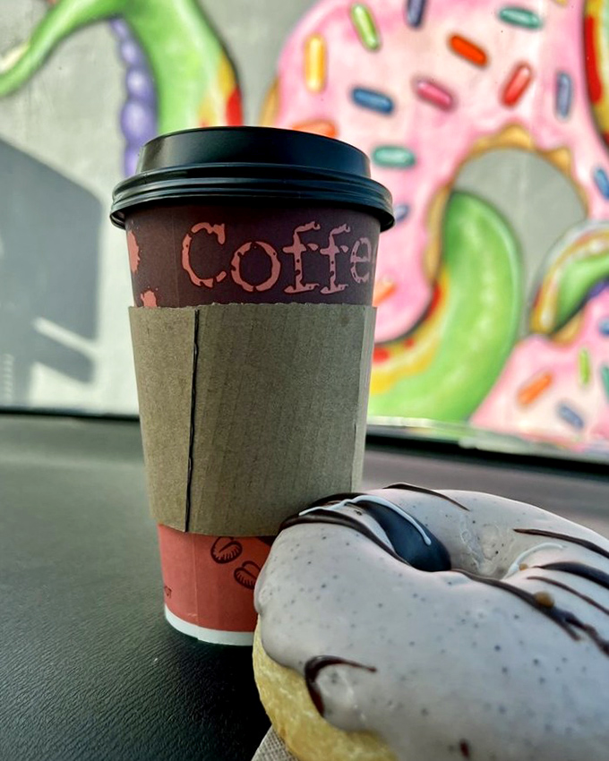 Coffee and donut&mdash;a pairing as timeless as Bogart and Bacall. The cup sleeve protects fingers while colorful donut art watches approvingly from the wall.