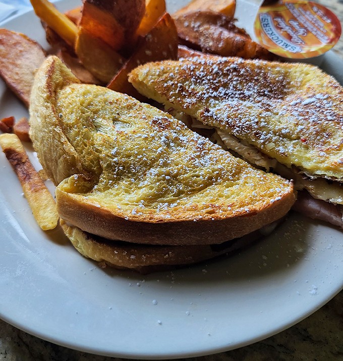 Monte Cristo sandwich golden as a summer sunset, dusted with sugar for good measure.