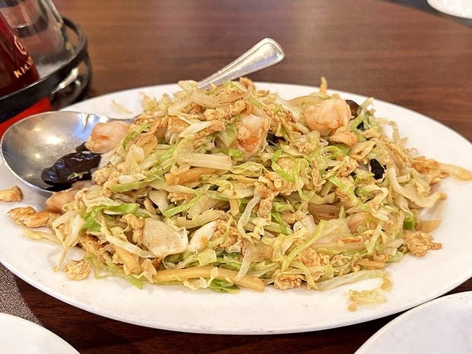 A mountain of stir-fried cabbage and protein that proves vegetables can be the life of the party when properly introduced to high heat.