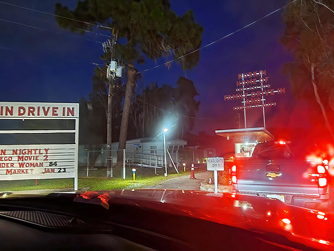 Night arrival at the Ruskin means following taillights to cinematic adventure. The illuminated marquee beckons like a lighthouse for movie lovers.