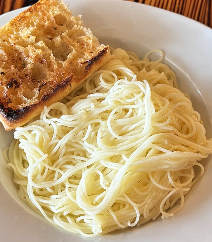Simple pasta with garlic bread &ndash; proof that sometimes the most basic combinations are the most satisfying. Comfort food speaks a universal language.