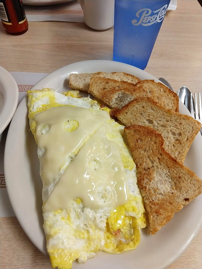 The perfect omelet doesn't exi&mdash; Oh wait, here it is, draped in melted cheese with toast soldiers standing guard. Breakfast royalty.