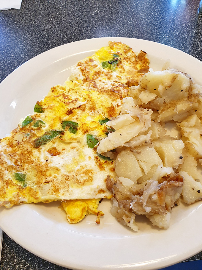 This omelet and home fries combo isn't just breakfast&mdash;it's fuel for champions, with perfectly folded eggs that would make a French chef tip their toque.