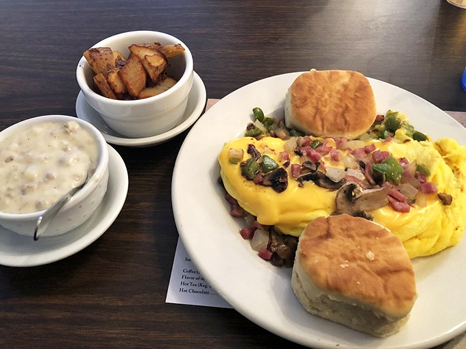 An omelet that's had a proper introduction to cheese. Those biscuits aren't just side dishes—they're supporting characters in this breakfast drama.