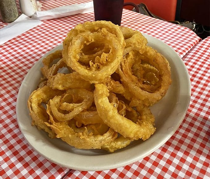 Onion rings with the perfect crunch-to-tenderness ratio. Each golden hoop is a portal to fried food nirvana.