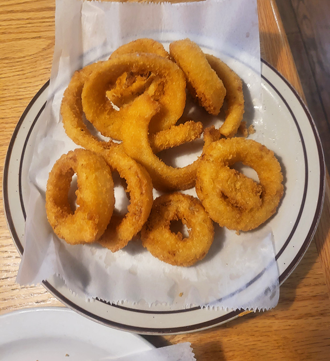 Onion rings that achieve that perfect balance between crispy coating and sweet, tender onion. The kind worth fighting over with your dining companion.