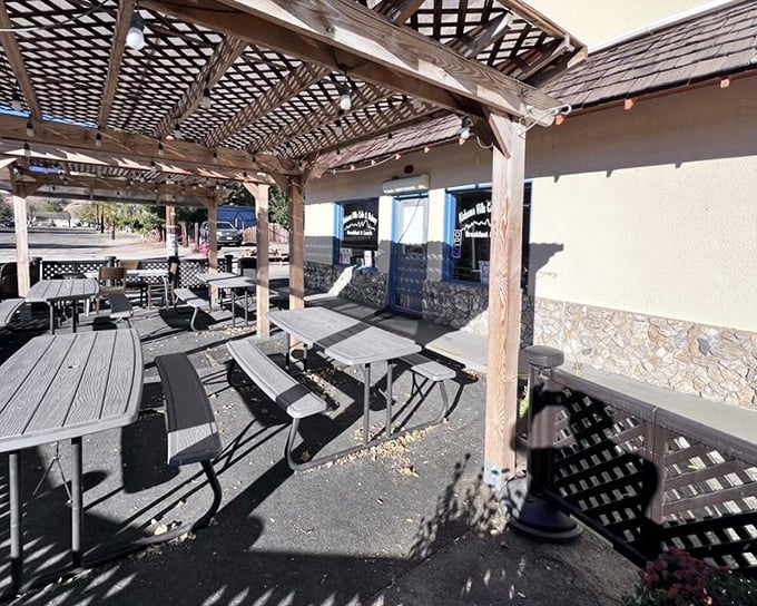 The outdoor seating area&mdash;where mountain air makes everything taste better. Simple picnic tables under dappled shade create breakfast nirvana.