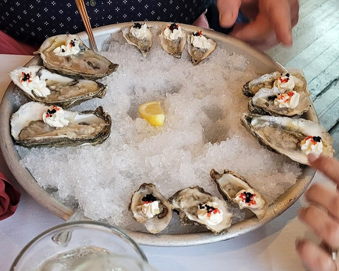 Raw oysters presented on ice like jewels on velvet&mdash;briny treasures topped with just enough garnish to enhance, never mask.