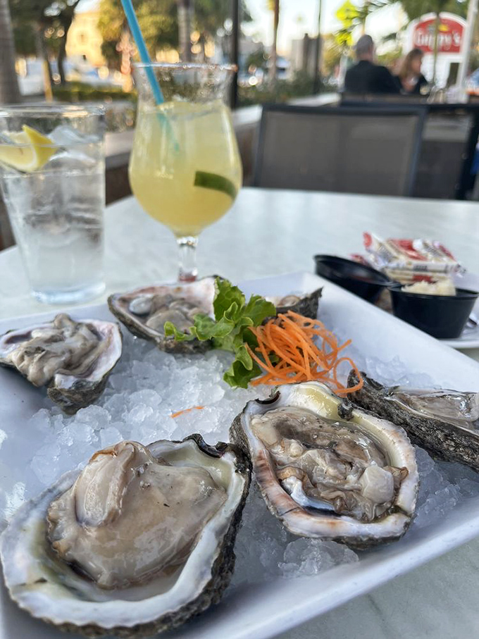 Fresh oysters on ice with a margarita nearby&mdash;this isn't just appetizer hour, it's Florida's version of living your best life.