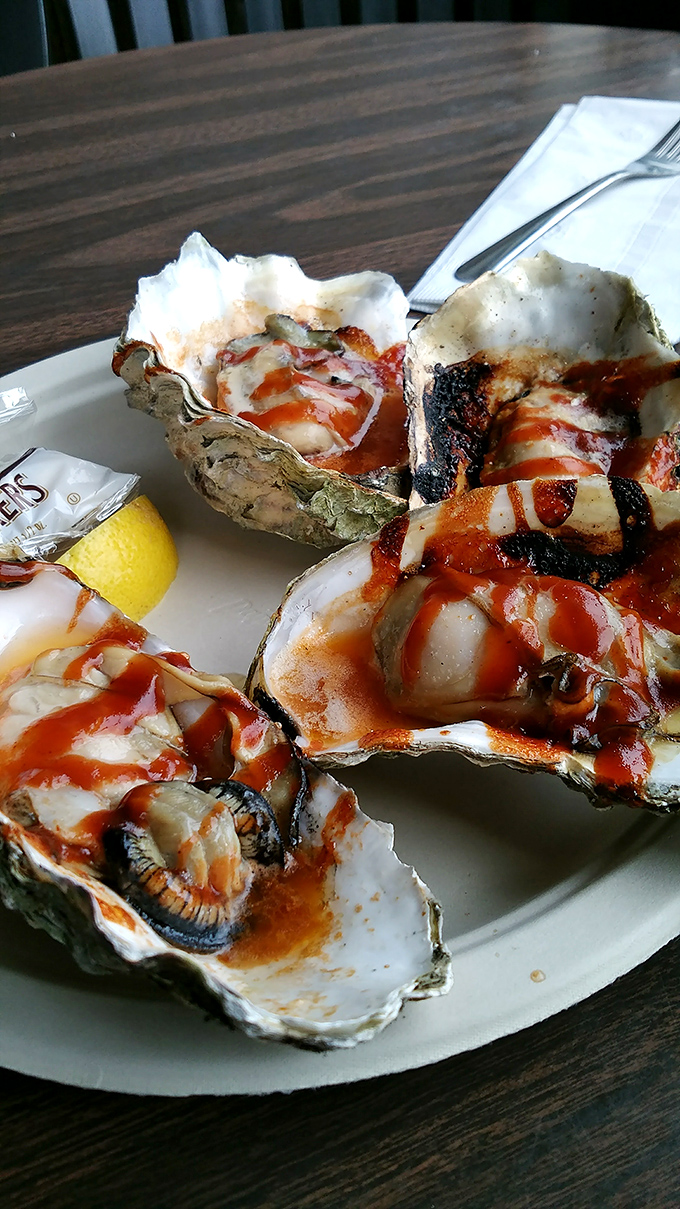 BBQ oysters glistening with sauce&mdash;ocean jewels transformed by fire and smoke into something that makes you forget your table manners.