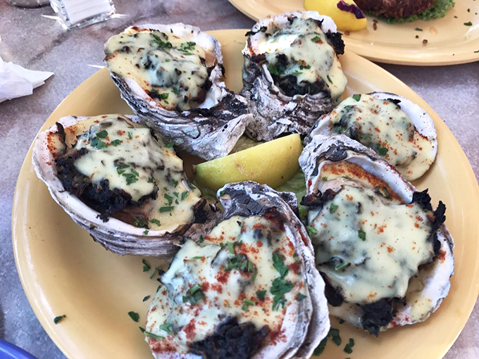These oysters Rockefeller are dressed better than most people at the opera. Bubbling cheese and herbs transform humble shellfish into coastal royalty. 