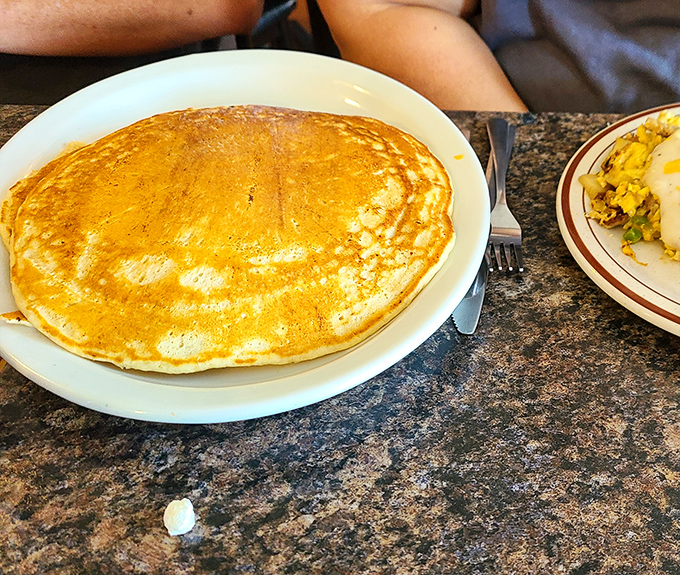 A pancake so perfectly golden it belongs in a museum, though it's destined for a much happier fate with maple syrup and butter.