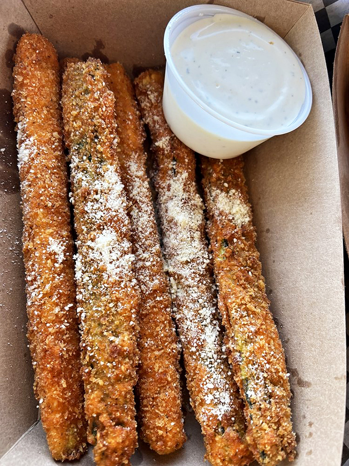 Parmesan zucchini sticks dusted with savory magic, served with dipping sauce that makes vegetables feel like an indulgence rather than a obligation.
