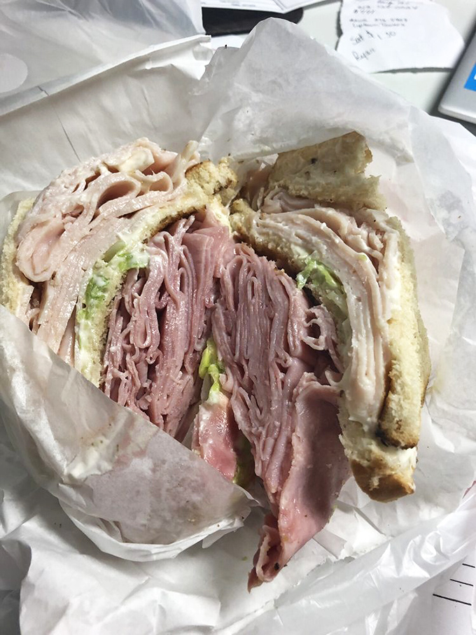 A deli sandwich stacked higher than some Cincinnati hills, with layers of meat that would make a carnivore weep with joy.
