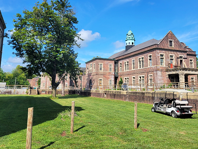 The distinctive copper-green cupola catches sunlight on a clear day, a beacon of architectural beauty amid the complex's sobering history.