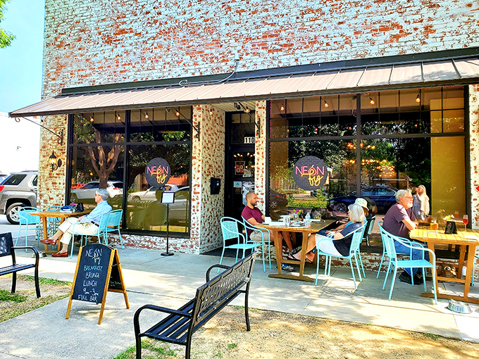 Neon Fig's outdoor dining scene proves that brick walls and turquoise chairs create the perfect backdrop for both people-watching and plate-savoring.