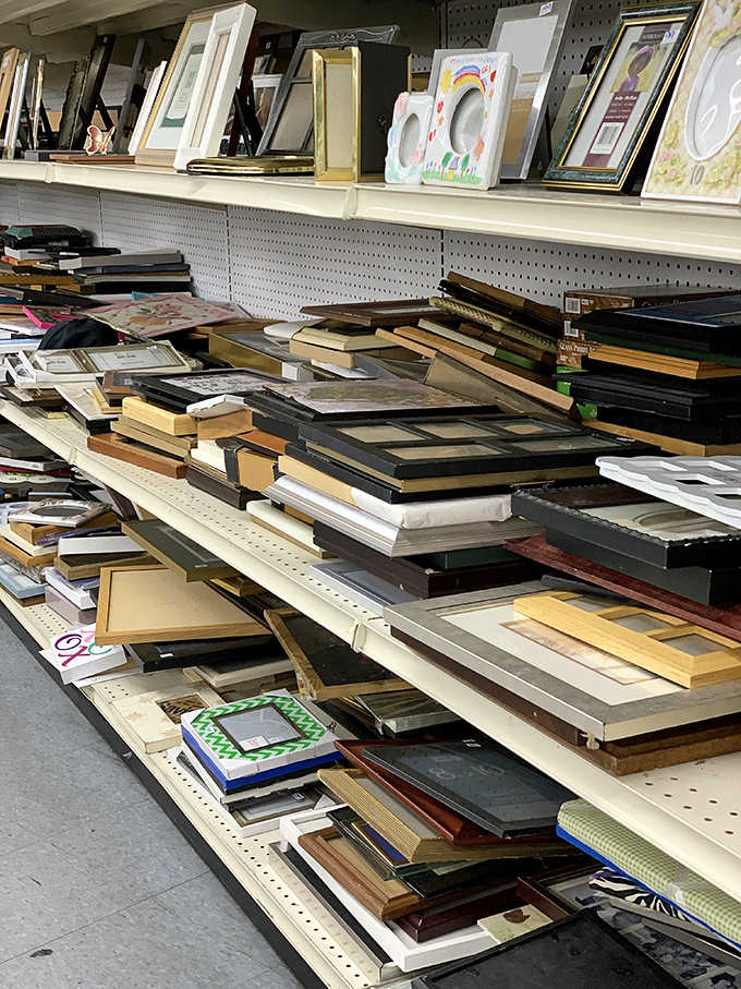 Picture frames and artwork line shelves, ready to transform blank walls into personalized gallery spaces.