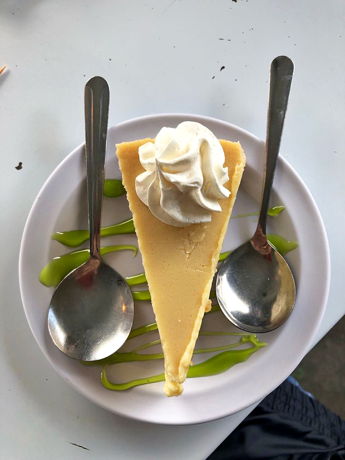 Key lime pie slice that understands Florida dessert traditions better than most tourists understand highway navigation systems.