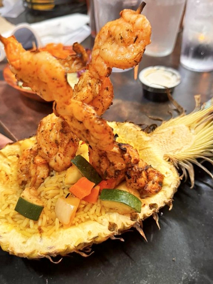 Shrimp skewers rising from pineapple rice like prehistoric spears &ndash; proof that presentation isn't just for fancy restaurants without dinosaur themes.