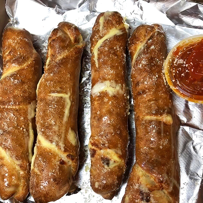 These pizza rolls aren't the freezer-aisle variety your teenager microwaves at midnight. Golden-brown, handmade treasures waiting for their marinara bath.