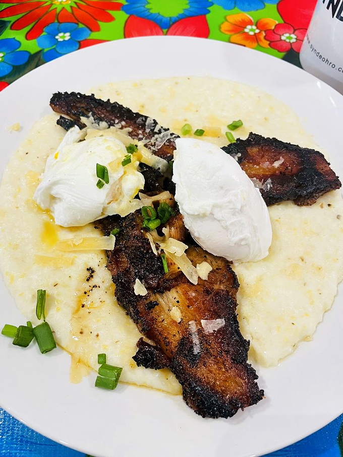 Crispy pork belly atop creamy grits with poached eggs&mdash;Southern comfort food that would make even a Yankees fan consider relocating below the Mason-Dixon.
